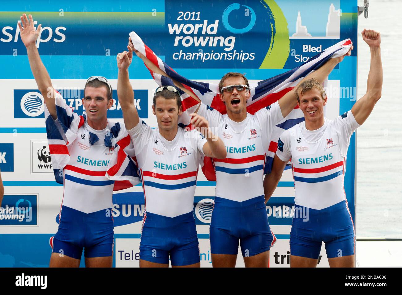 The team of Great Britain celebrates on the podium after taking the ...