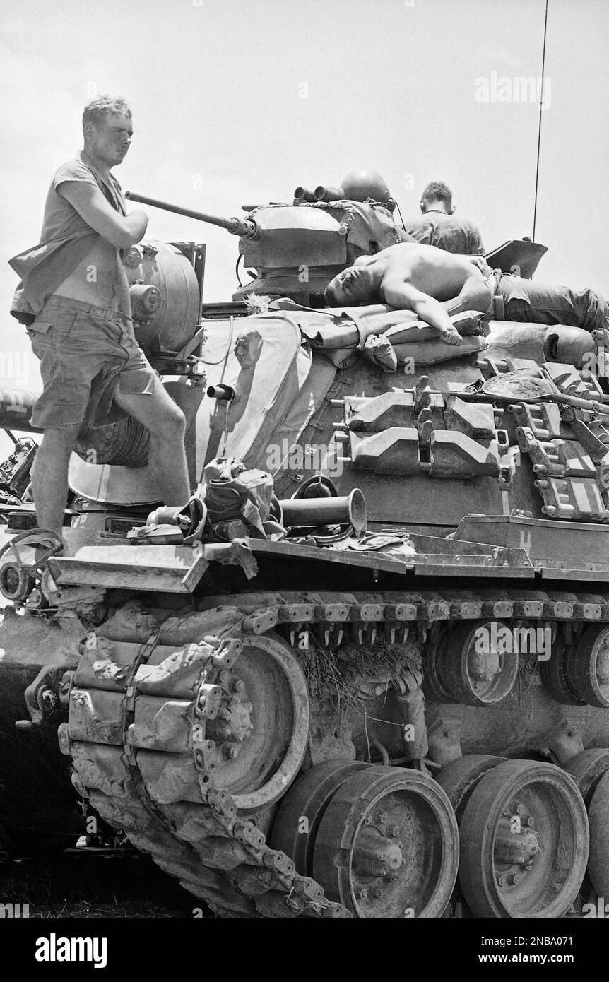 A dead U.S. Marine lies atop a heavy tank after being evacuated from ...