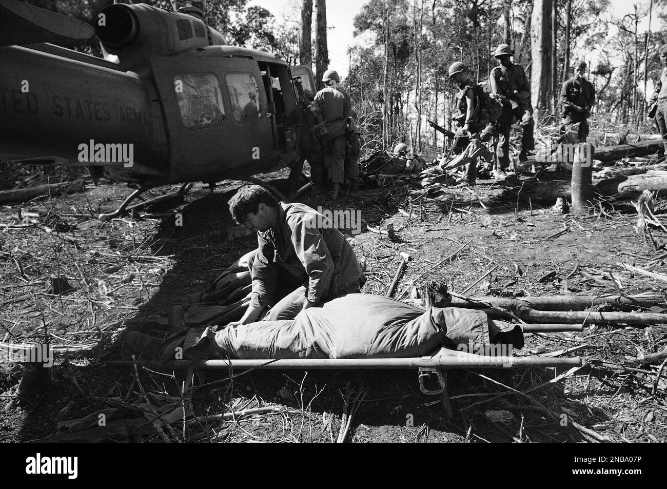 U.S. 4th Division soldier tucks poncho neatly around body of dead ...
