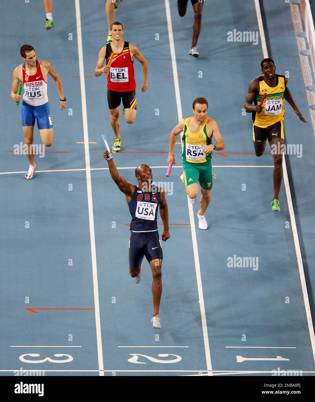 USA's LaShawn Merritt, center front, goes to cross the finish line to ...