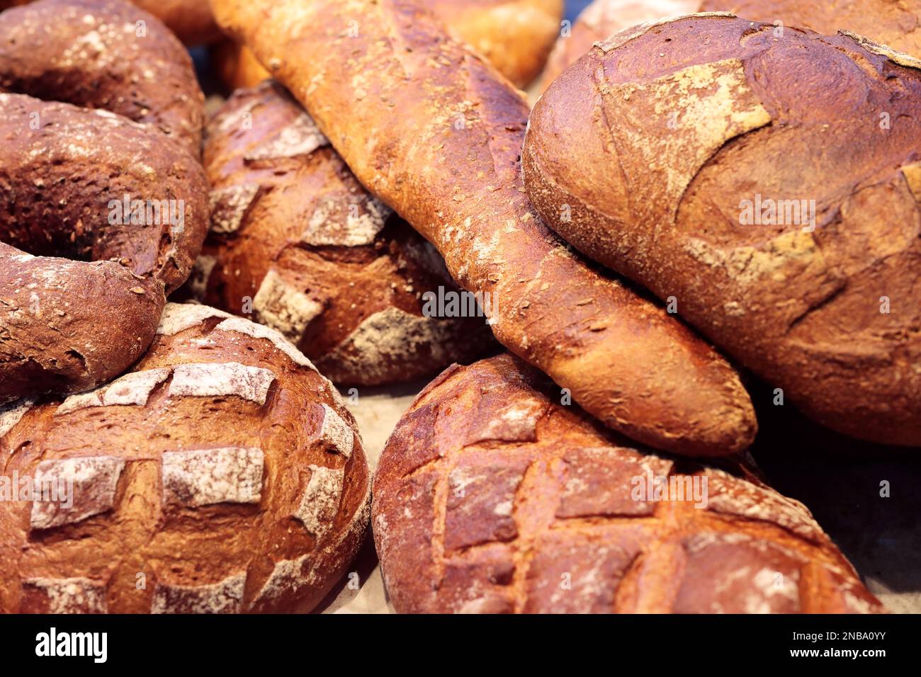 Different kinds of bread loaves on bakery counter. Selective focus ...