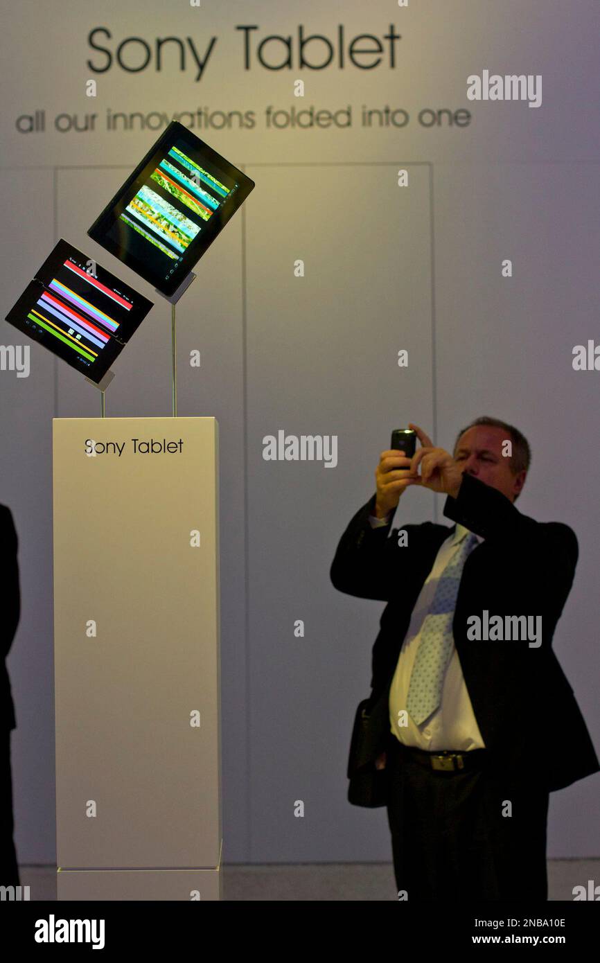 A visitor takes a photo of Sony tablets with his cell phone at the Sony ...