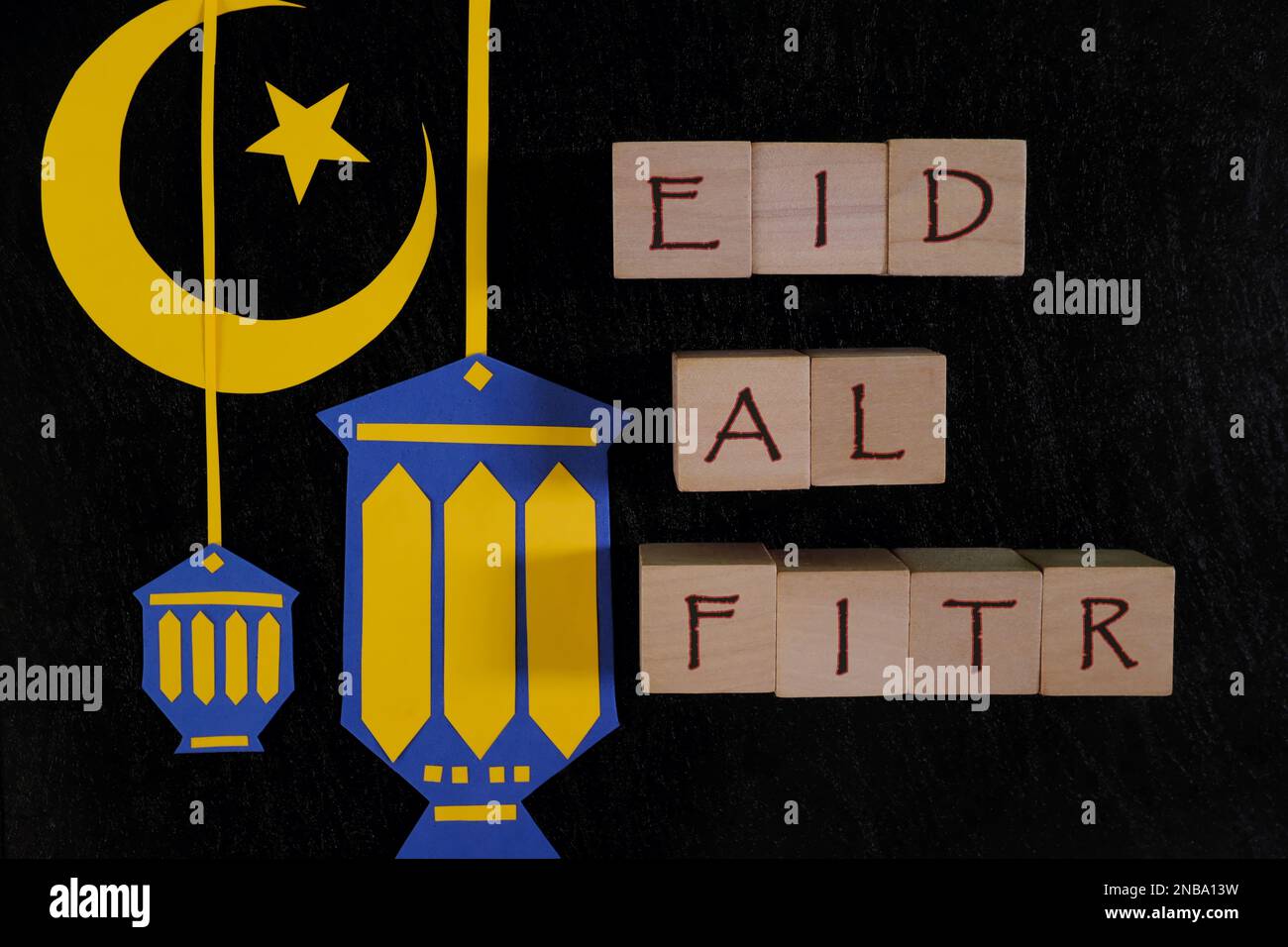 Crescent moon, star and lantern decoration with text on wooden blocks ...