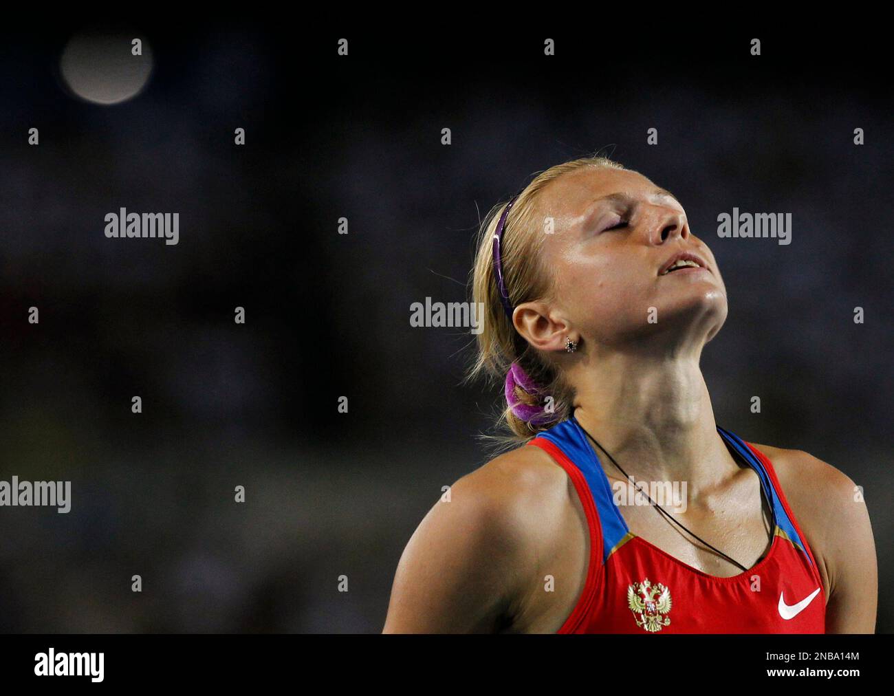 Russia's Yuliya Rusanova reacts after crossing the finish line first in ...
