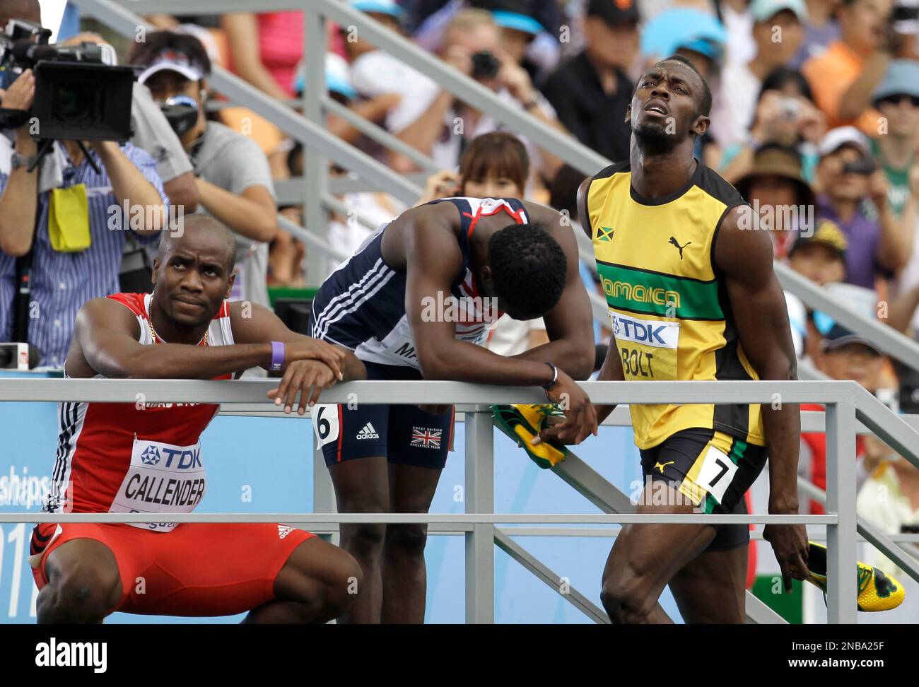 Jamaica's Usain Bolt, right, watches the heat result of their Men's ...