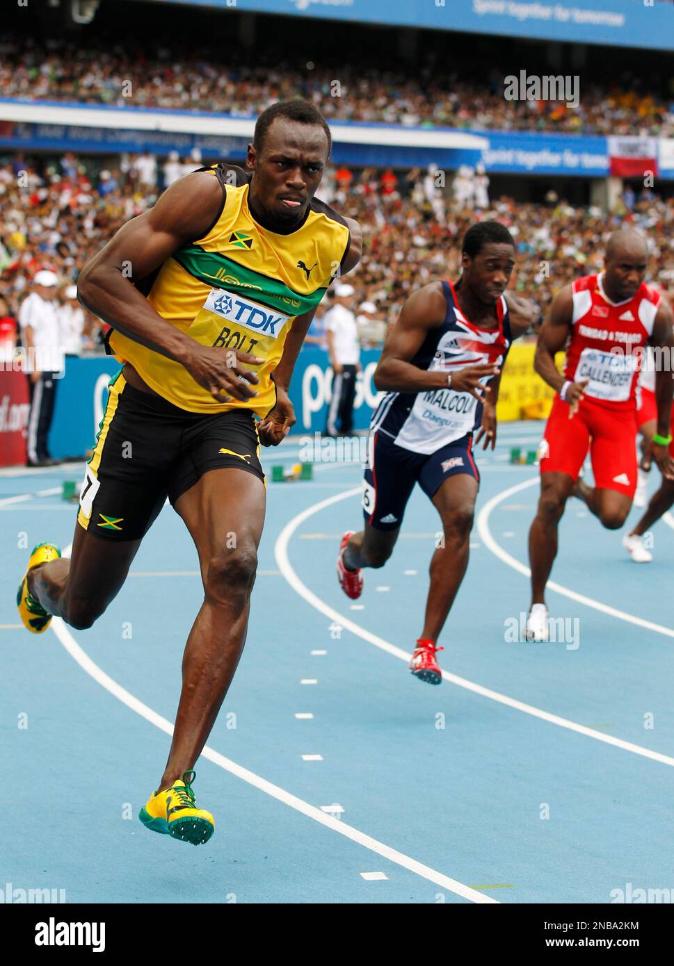 Jamaica's Usain Bolt, left, Britain's Christian Malcolm, center, and ...