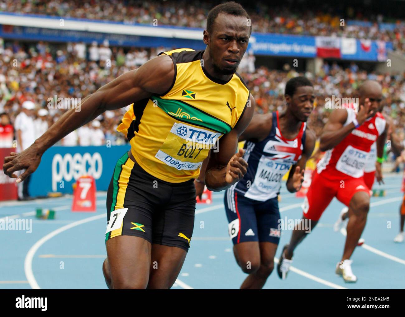 Jamaica's Usain Bolt, left, Britain's Christian Malcolm, center, and ...