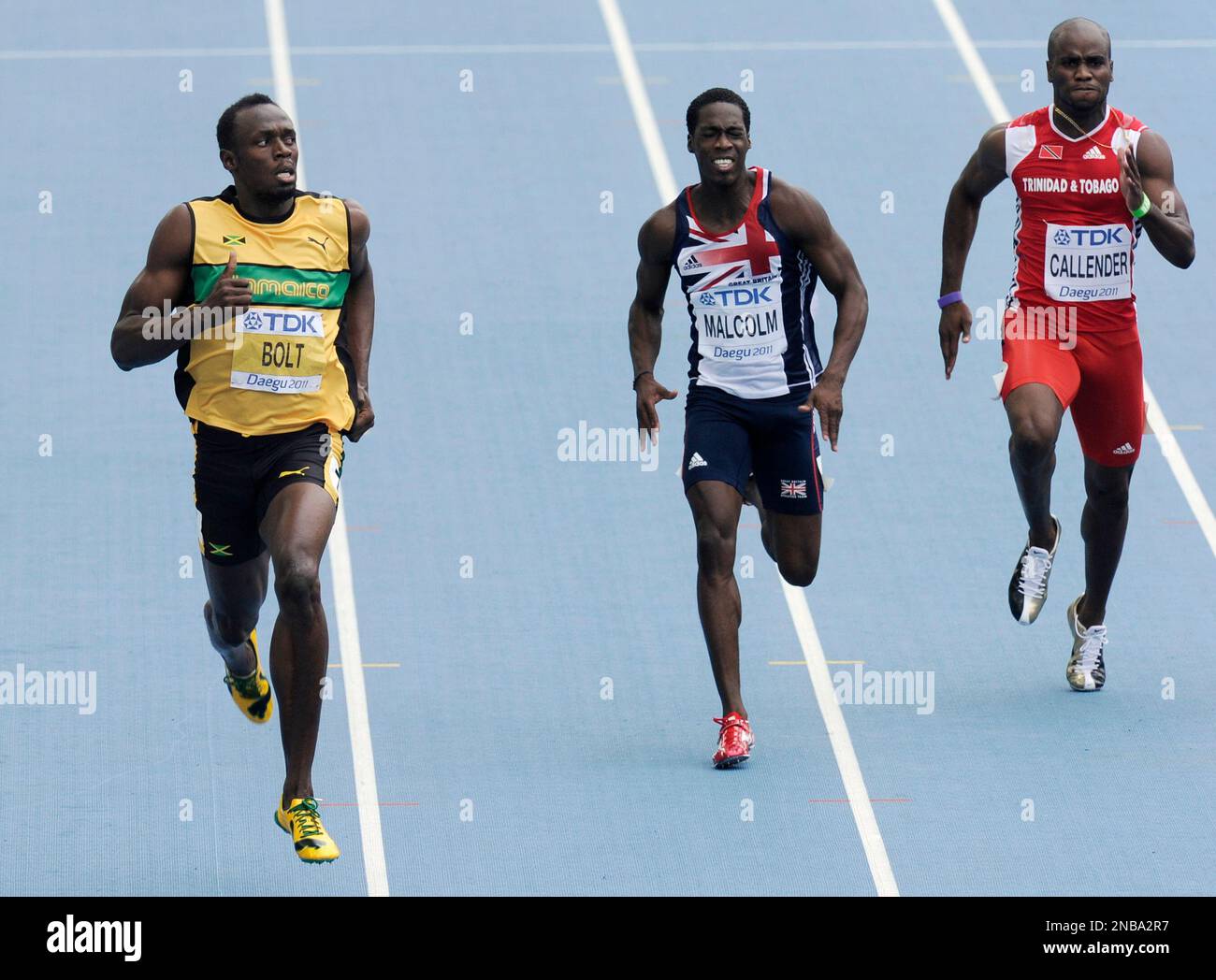 Jamaica's Usain Bolt, left, goes to cross the finish line ahead of ...