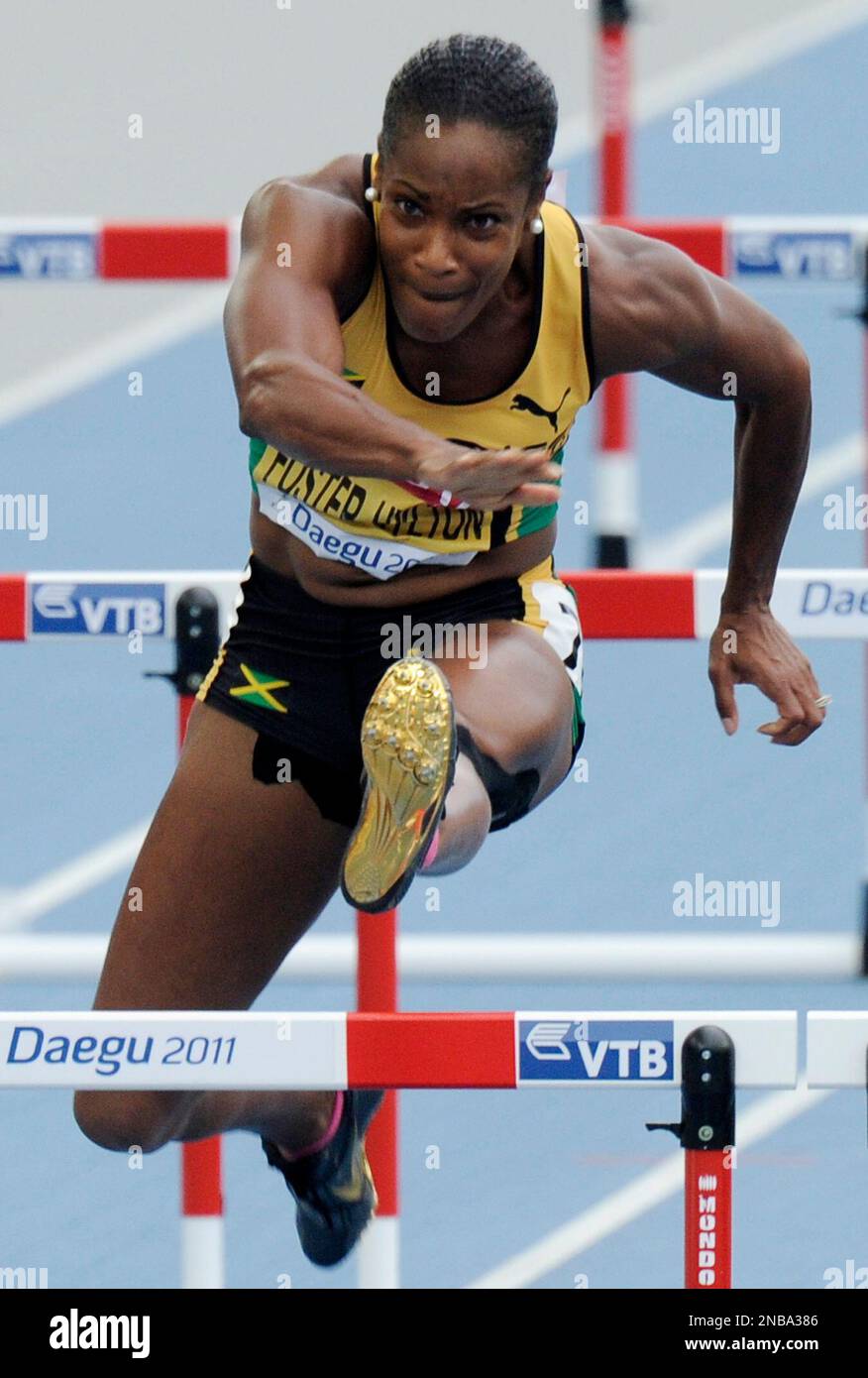 Jamaica's Brigitte Foster-Hylton clears a hurdle in a Women's 100m ...