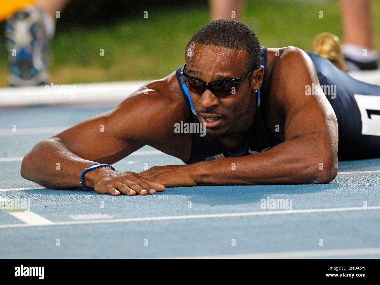 USA's Angelo Taylor lies on the track after placing seventh in the Men ...