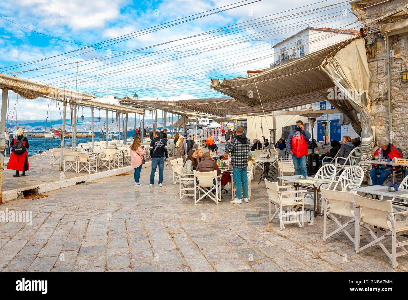 View from a waterfront sidewalk cafe of the sea and boats in the harbor ...