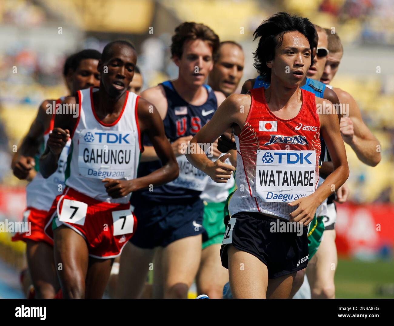 Japan's Kazuya Watanabe, right, competes in a Men's 5000m heat at the ...