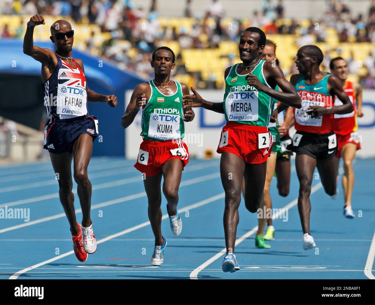 Ethiopia’s Imane Merga, right, crosses the finish line ahead of Britain ...