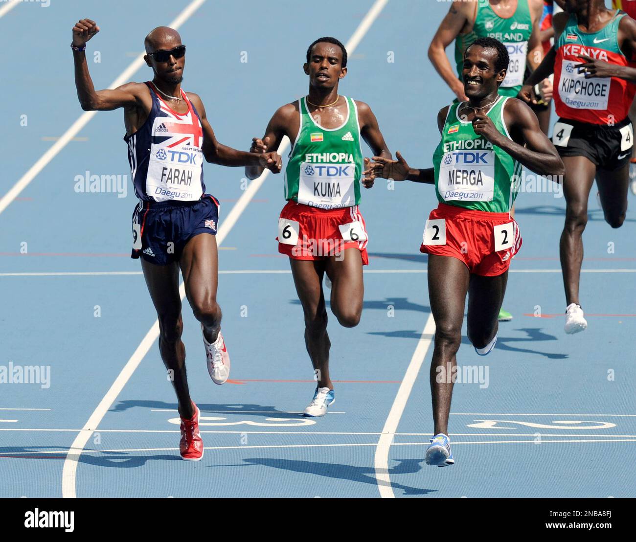 Ethiopia’s Imane Merga, right, crosses the finish line ahead of Britain ...