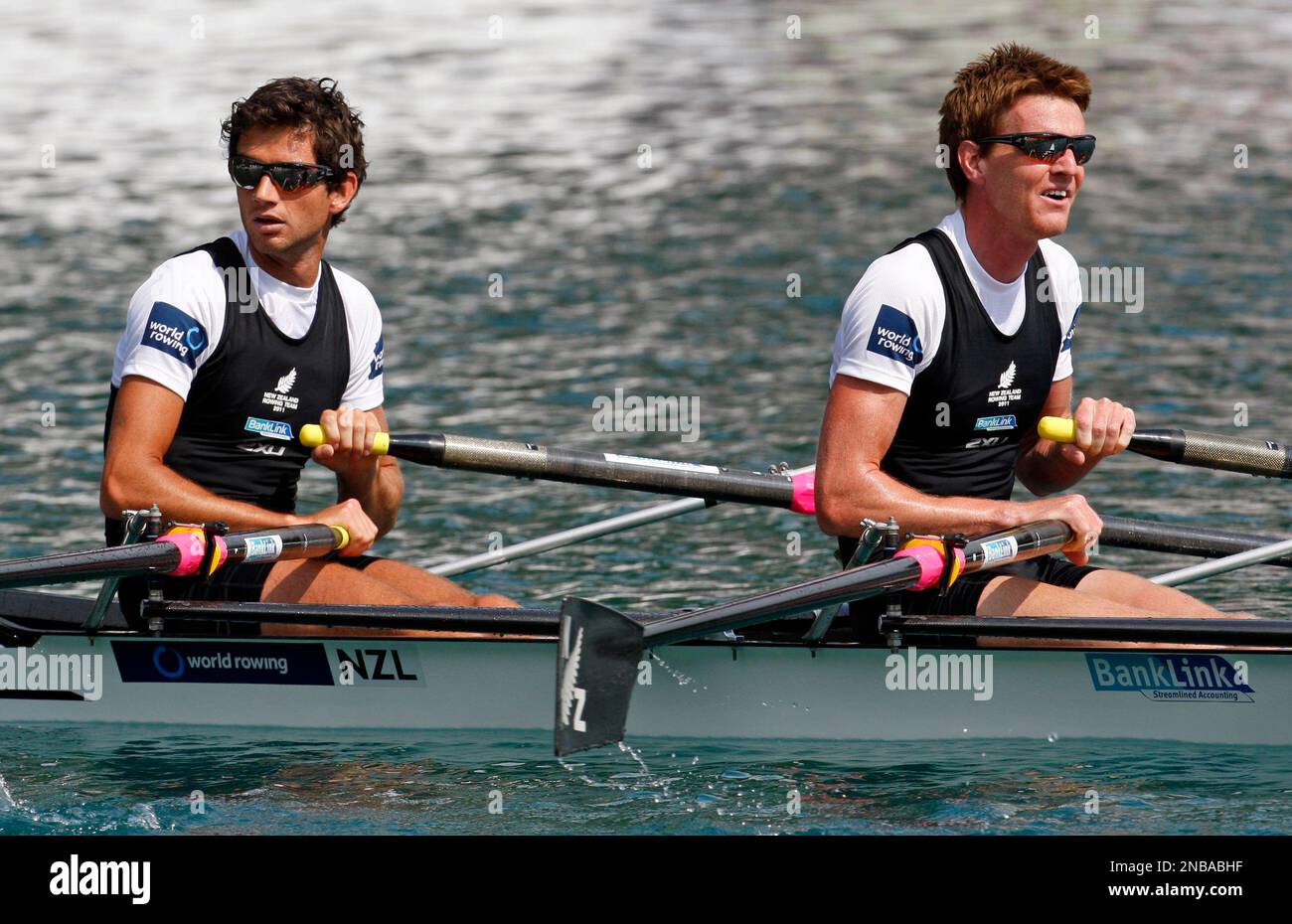 New Zealand's Storm Uru, left and Peter Taylor react at the finish line ...