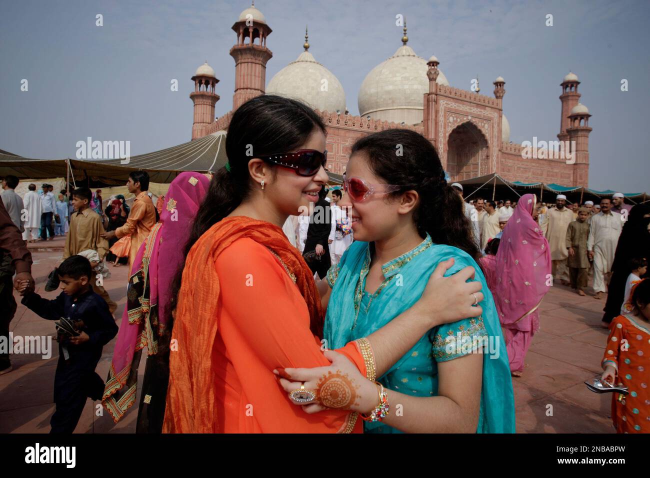 Pakistani Muslim women share Eid greeting after the prayers of Eid al ...