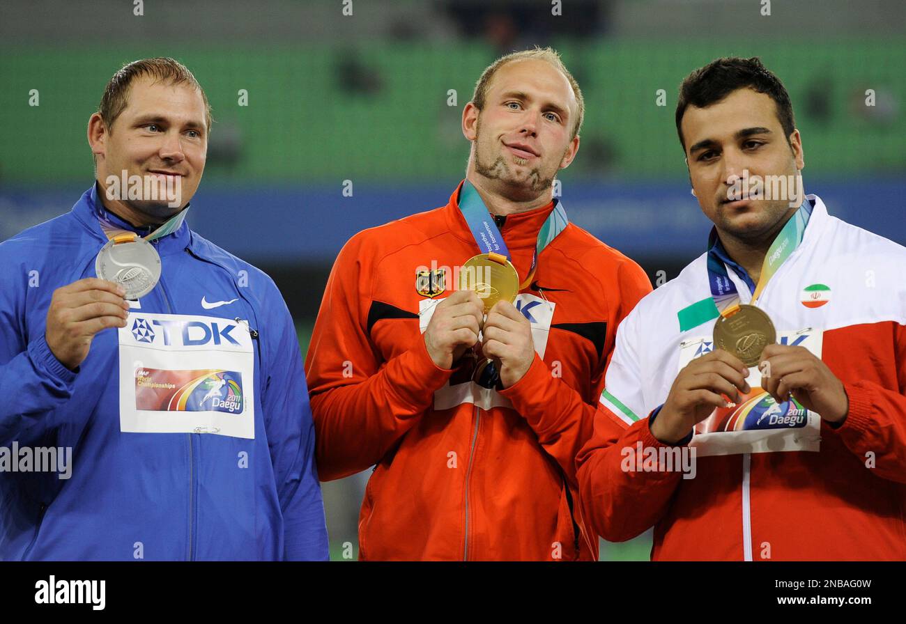 Germany's Robert Harting, center, Estonia's Gerd Kanter, left, and Iran ...