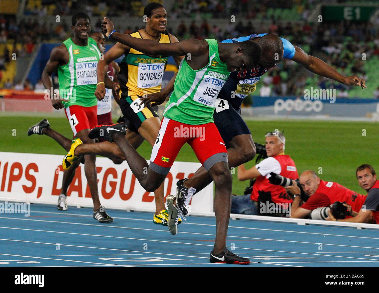 Grenada's Kirani James, front left, crosses the finish line ahead of ...