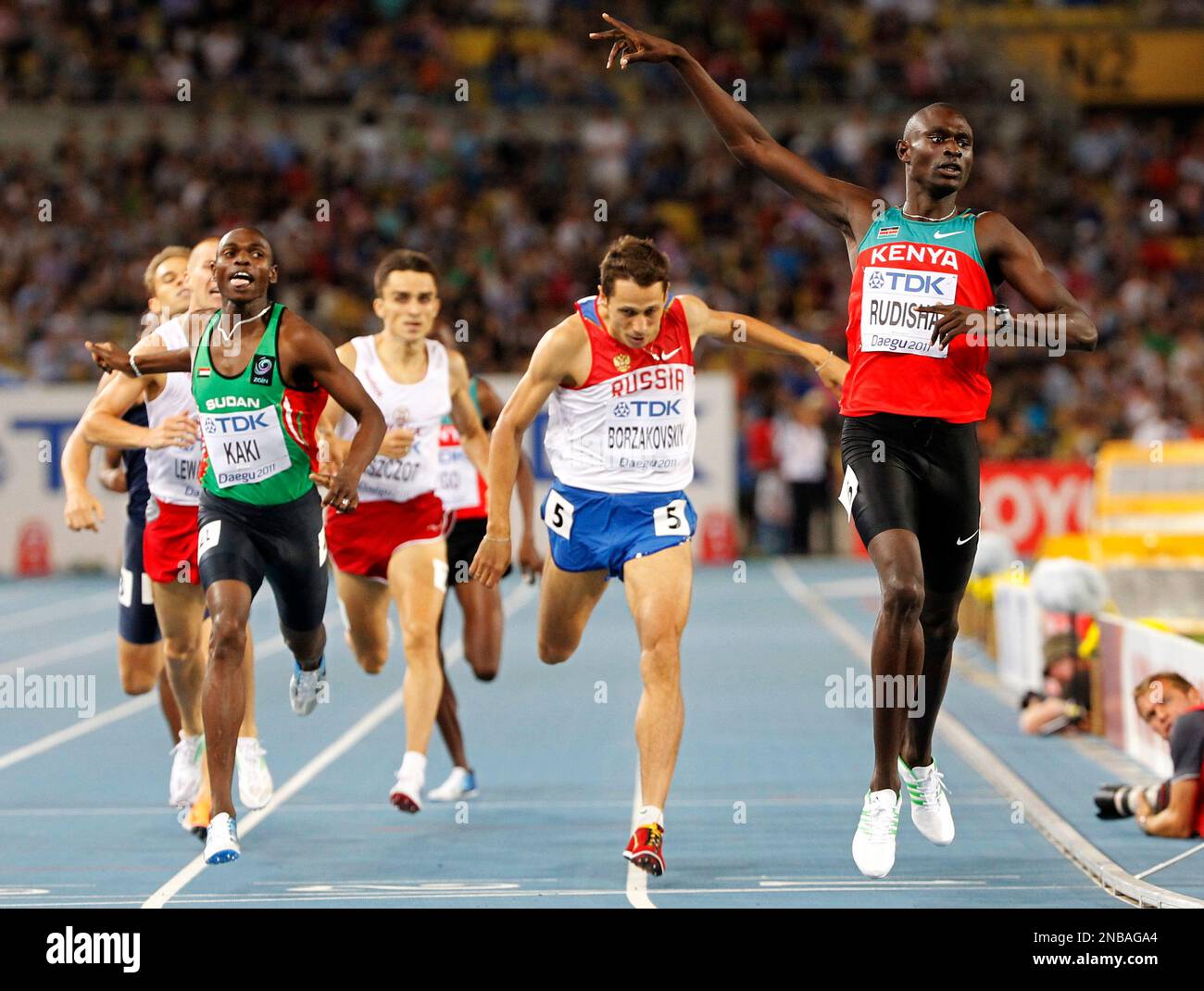 Kenya's David Lekuta Rudisha, right, reacts as he crosses the finish ...