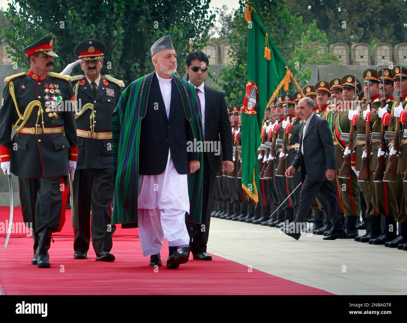 Afghan President Hamid Karzai, center, inspects the honor guards before ...