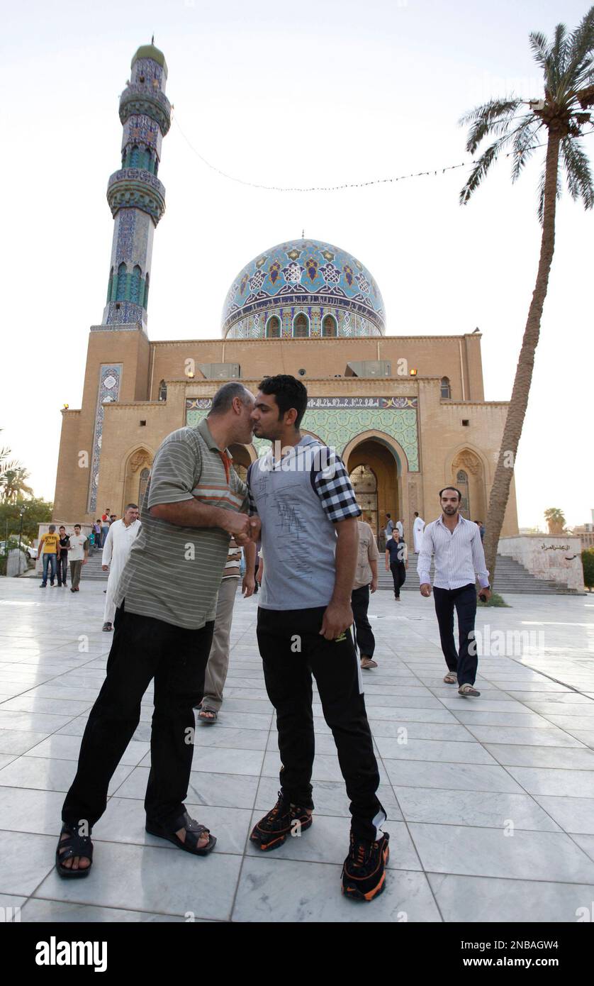 Iraqi Sunni Muslims exchange greetings after Eid prayers outside the ...