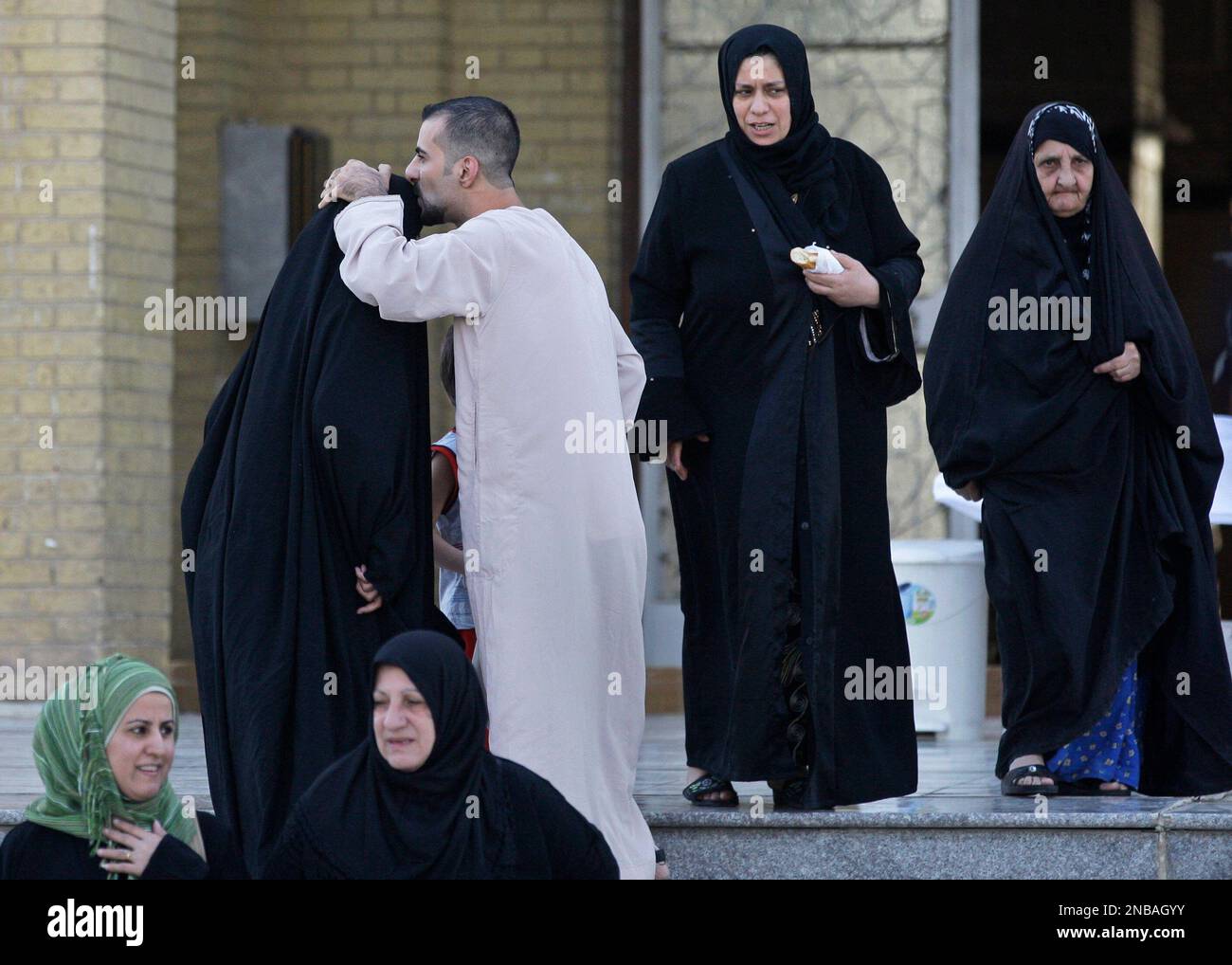 Iraqi Sunni Muslims exchange greetings after Eid prayers outside the ...