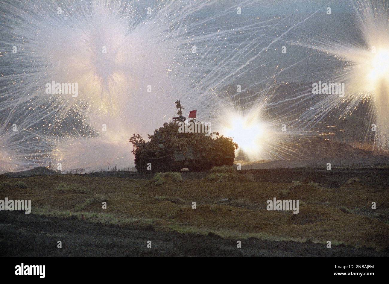 An advancing tank of the Japan Ground-Self Defense Force is silhouetted ...