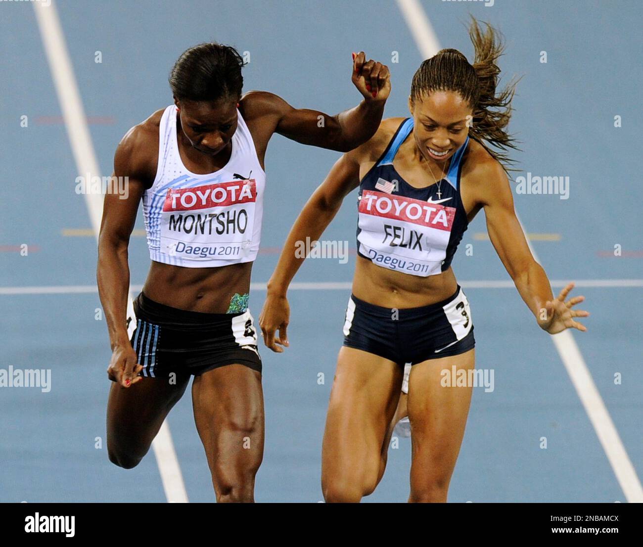 Botswana's Amantle Montsho, left, crosses the finish line ahead of USA ...