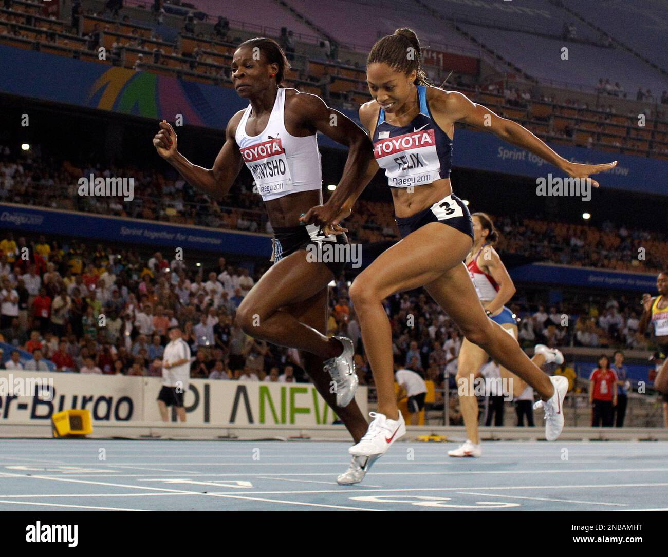 Amantle Montsho of Botswana, left, crosses the finish line to winning ...