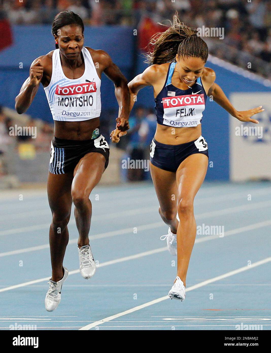 Botswana's Amantle Montsho, left, crosses the finish line ahead of USA ...
