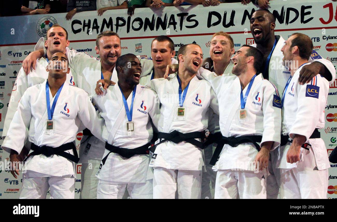 France's team pose with their gold medals of the men's team competition ...