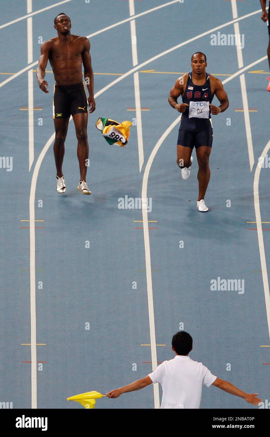 Jamaica's Usain Bolt, left, reacts as he is disqualified for a false ...