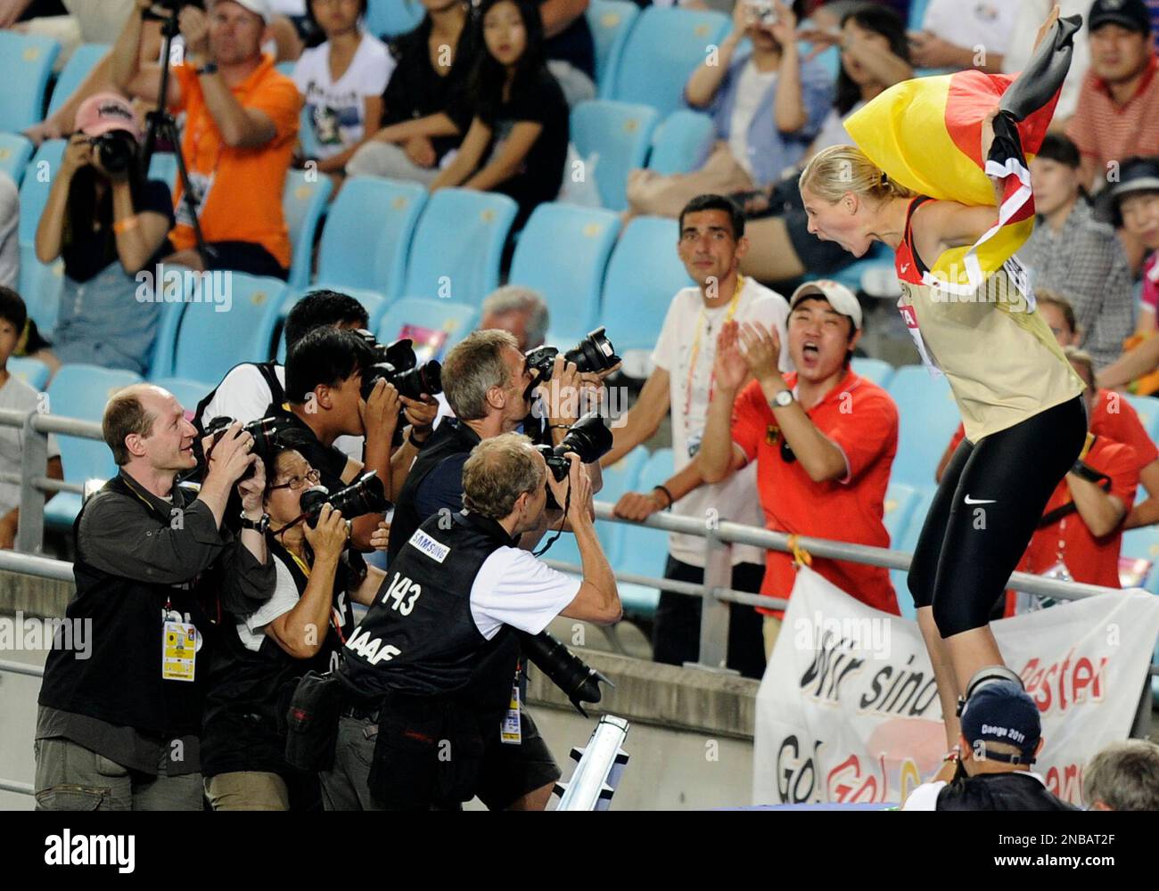Germany's Nadine Muller, right, celebrates winning silver in the Women ...
