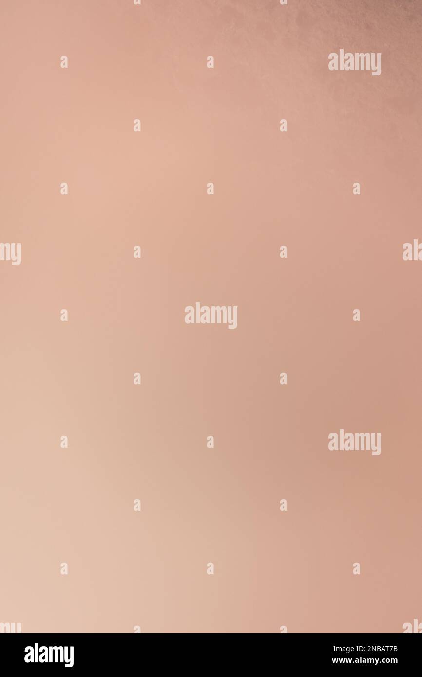 A dull beige background with minimal texture and a soft color gradient ...