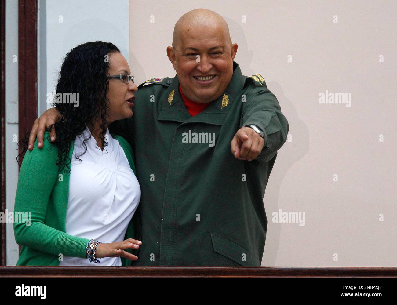 Venezuela's President Hugo Chavez, right, points to his supporters ...