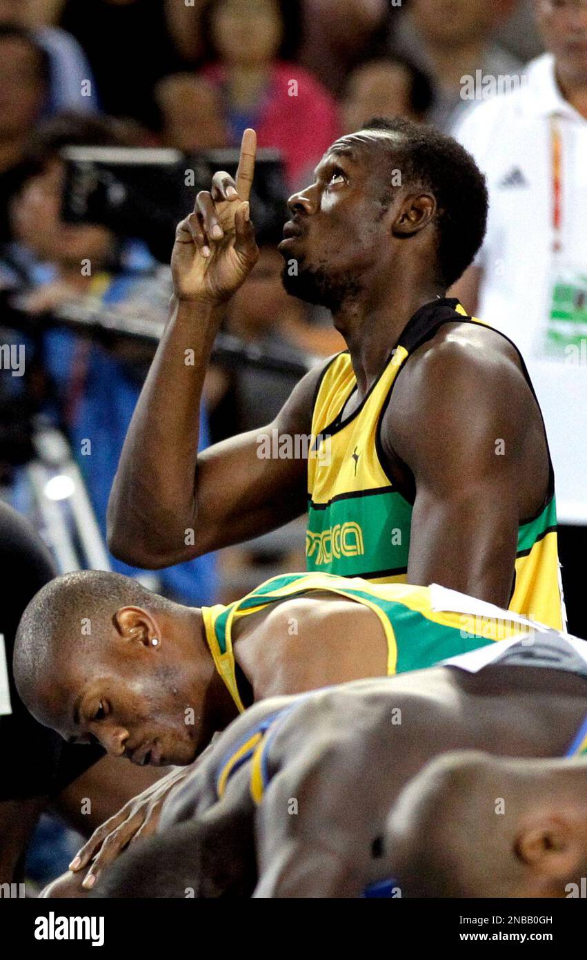 Jamaica's Usain Bolt points at the sky before the first round heat of ...