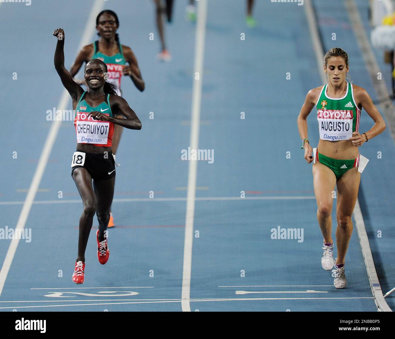 Kenya's Vivian Jepkemoi Cheruiyot, left, celebrates crossing the finish ...