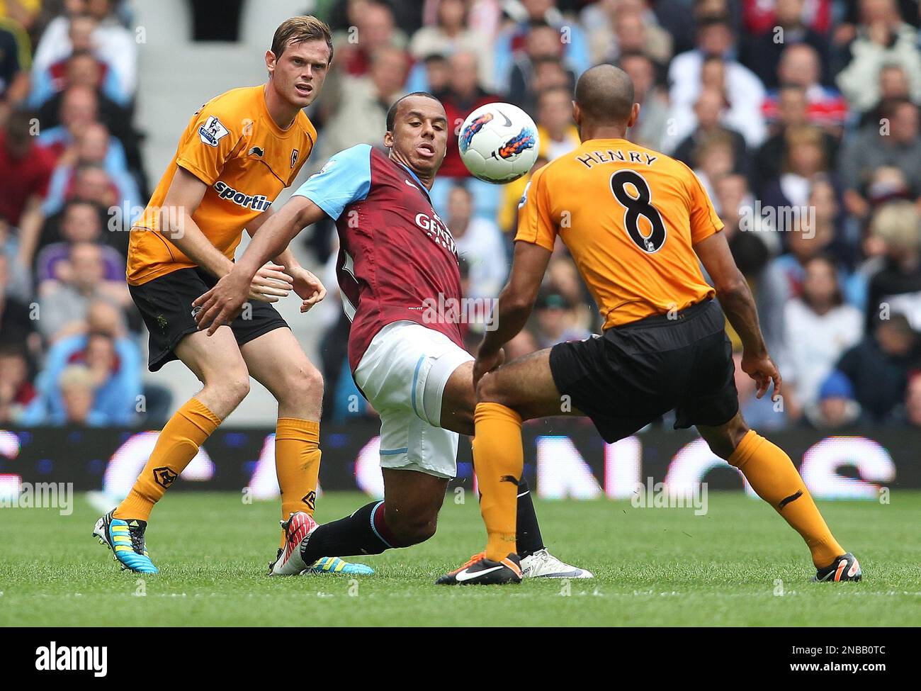 Aston Villa's Gabriel Agbonlahor, center, competes for the ball with ...