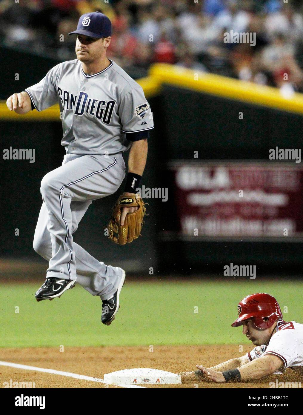 San Diego Padres' Logan Forsythe, left, leaps out of the way as Arizona ...