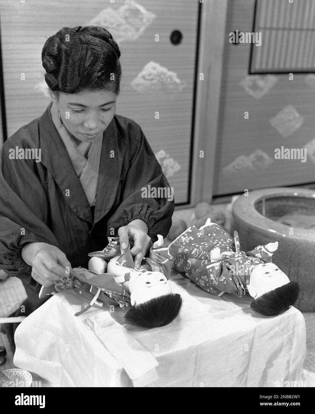 Mrs. Fujimura, wife of Toshio, the doll maker, who has hand-sewn doll ...