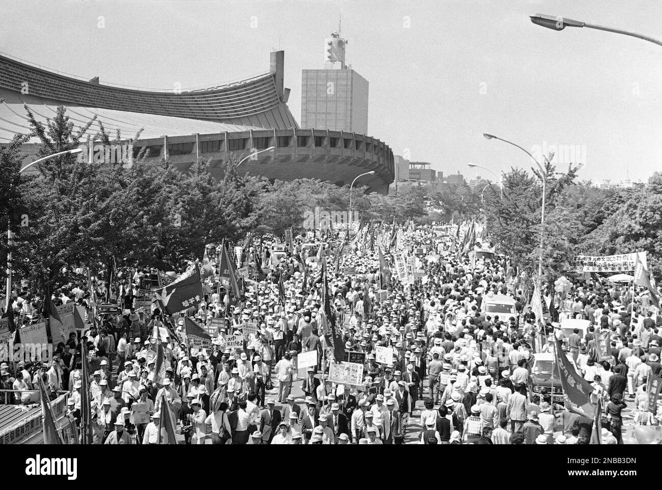 Carrying banners and placards with slogans, thousands of workers gather ...