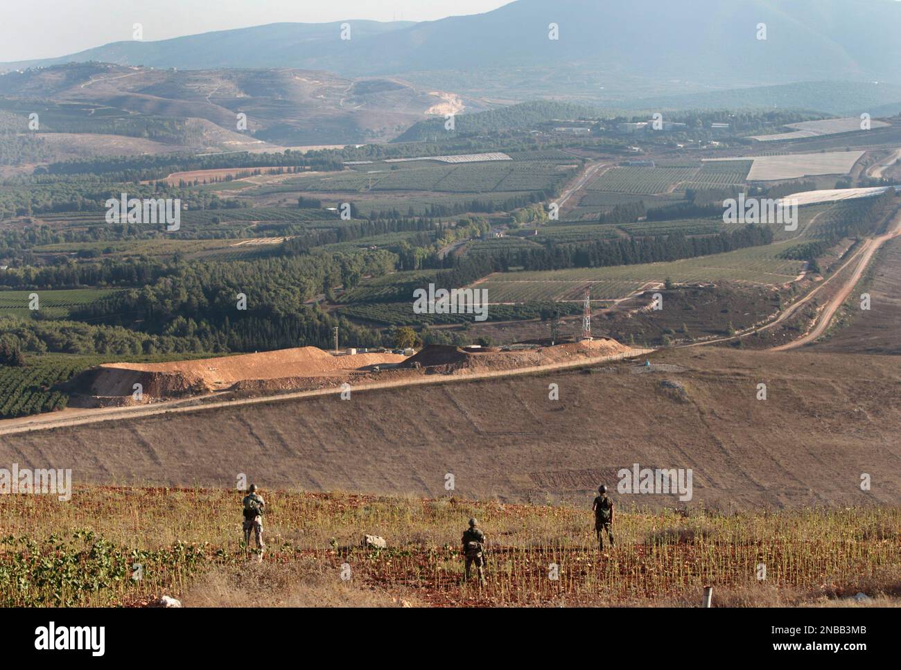 Lebanese army soldiers stand guard at a hill facing the Israeli border ...
