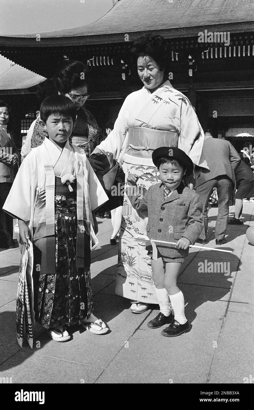 Mother and boys in rivaling colorful kimonos at Shichi-Go-San festival ...
