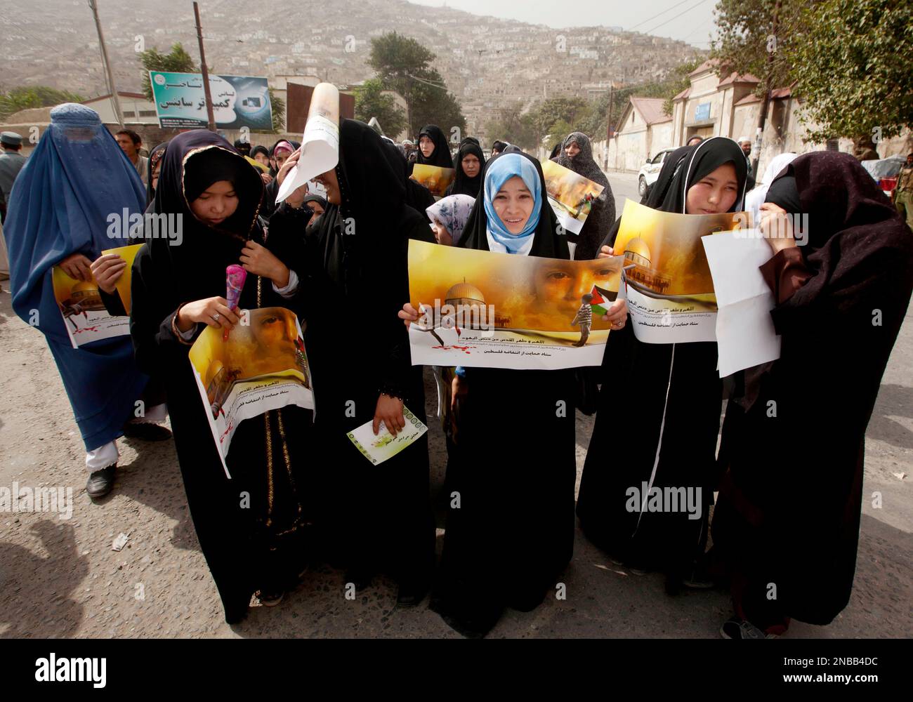 Afghan girls hold posters showing Al Aqsa Mosque, during a protest to ...
