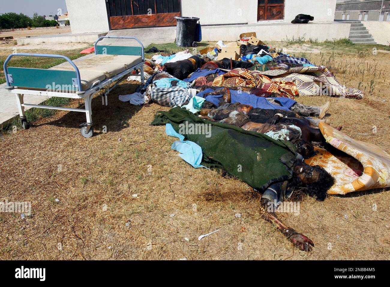 ED NOTE GRAPHIC CONTENT -- Dead bodies lay outside the hospital in the ...