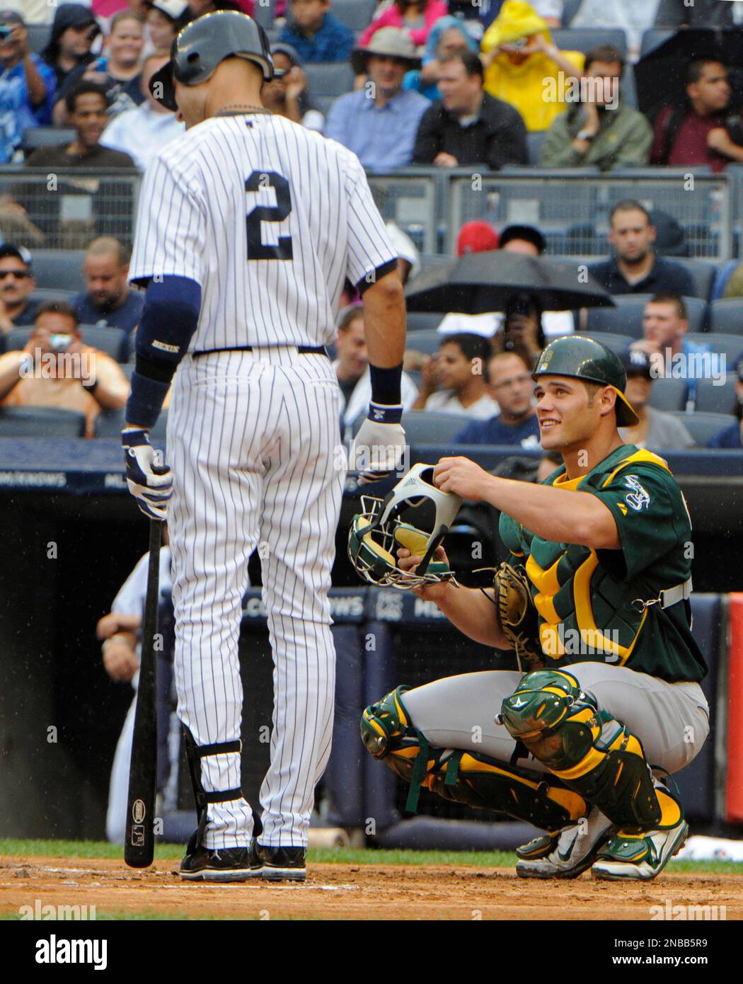 Oakland Athletics catcher Anthony Recker, right, looks up at New York ...