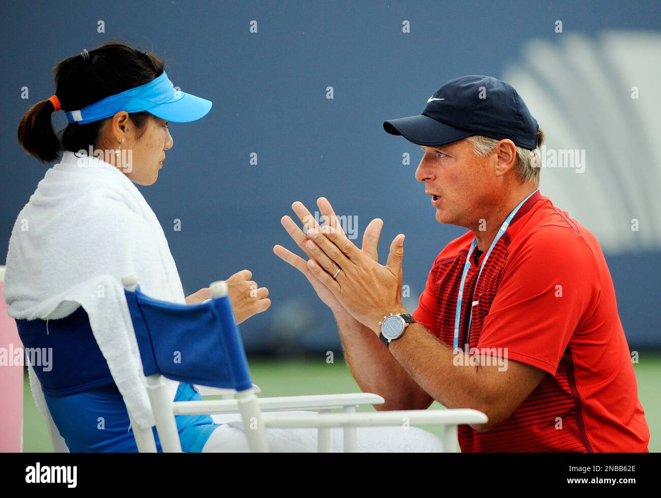 Li Na, of China, speaks with her coach Michael Mortensen during a break ...