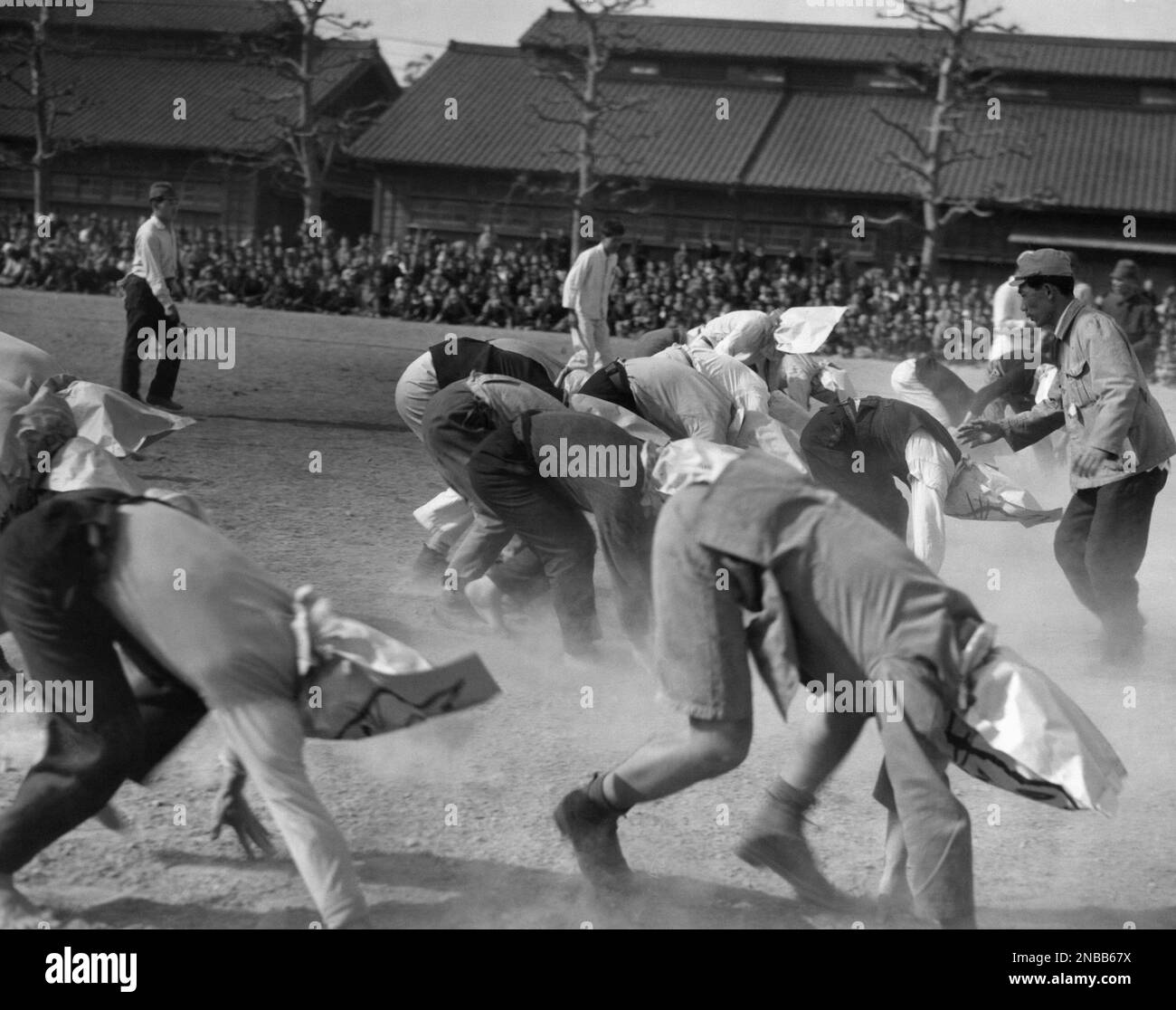 The Potato Race is underway as the contestants, employees of the ...