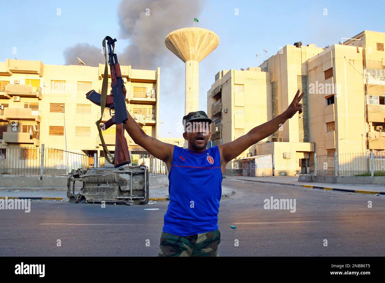 A Libyan rebel gestures in Abu Salim district in Tripoli, Libya ...