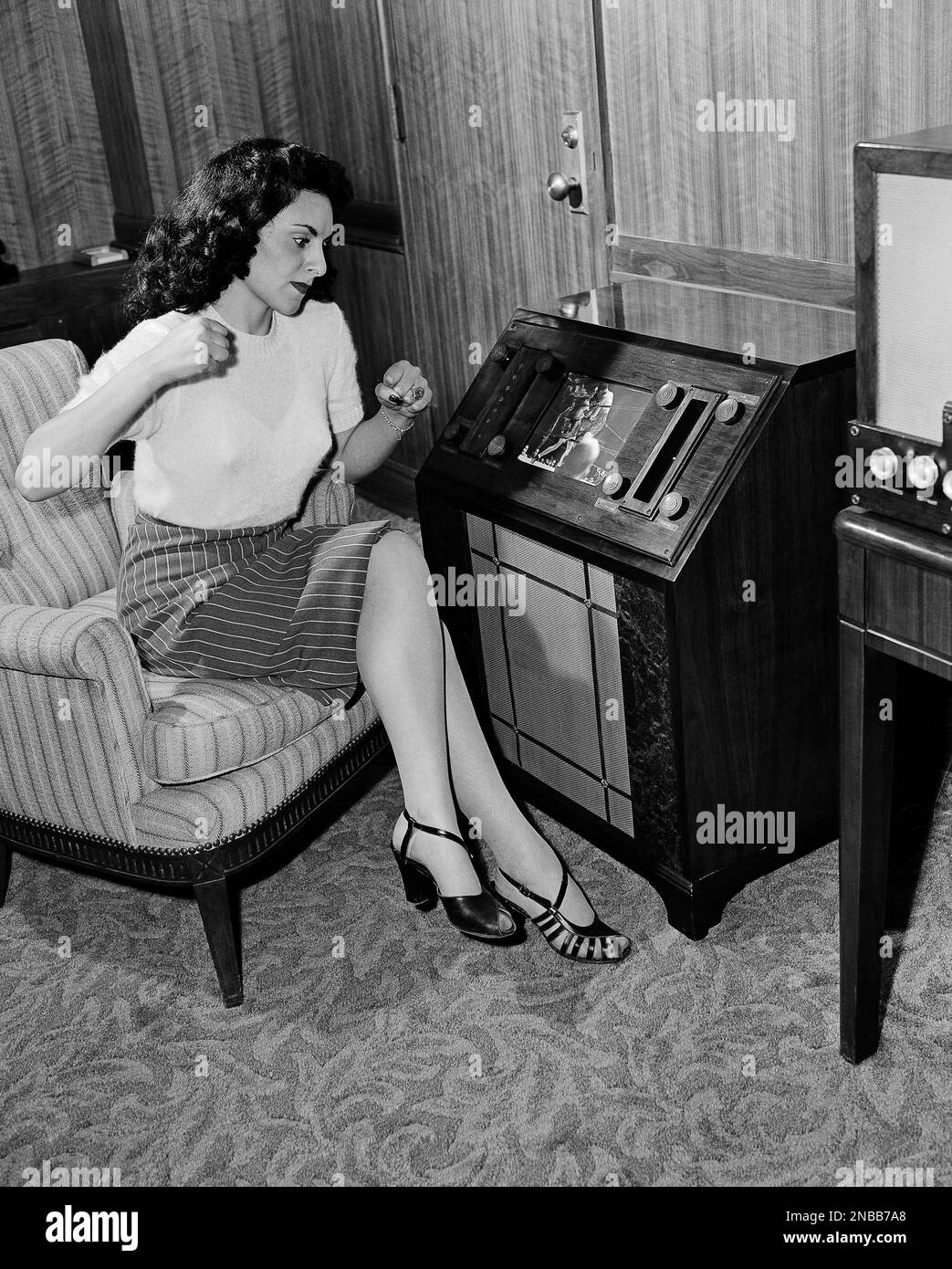 A large-view (ten-inch screen) console model television set and a small ...
